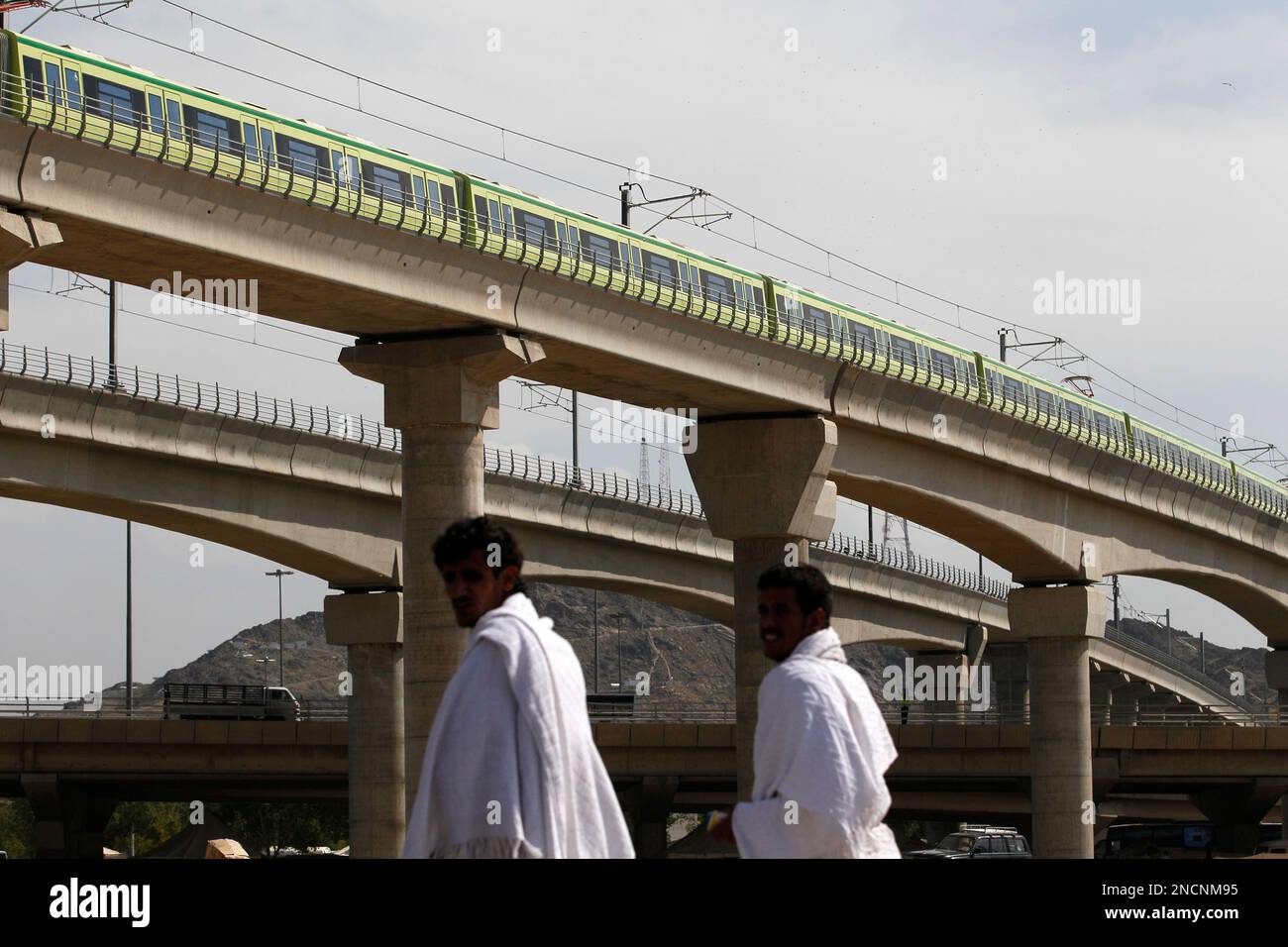 A Mecca Metro train passes over Muslim pilgrims' heads towards Mina ...