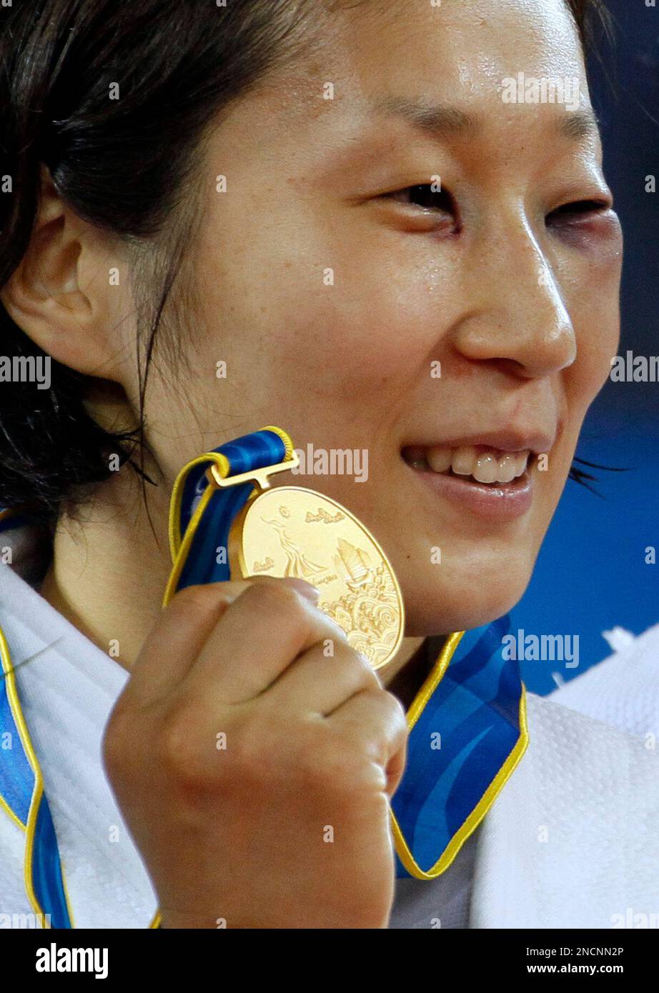 Japan's Yoshie Ueno holds up her gold medal during the medal ceremony for the women's judo -63kg ...