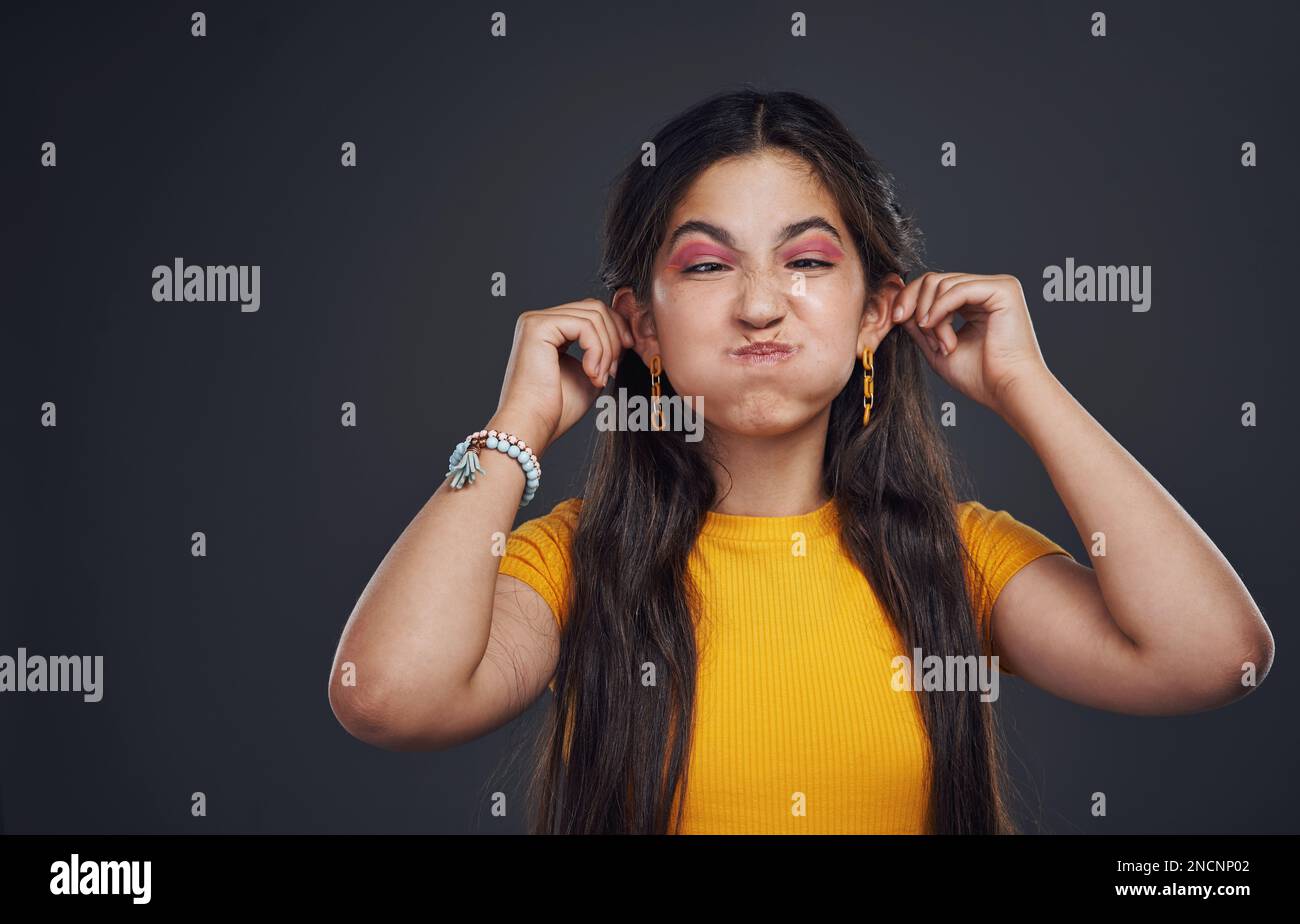 Guess the expression. an attractive teenage girl standing alone and ...