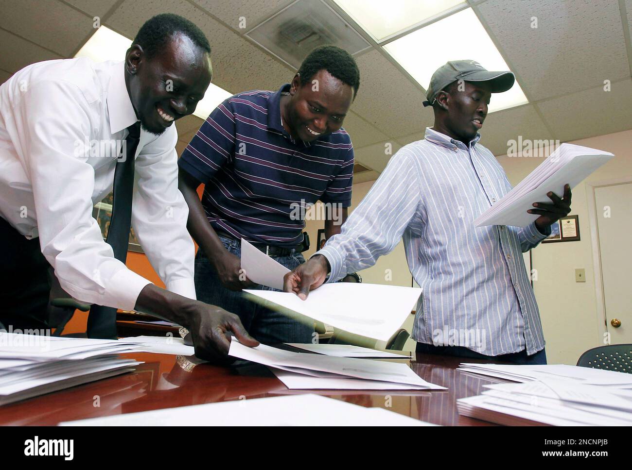 From left to right, Ajak Dau Akech, Kuol Awan, executive director of ...