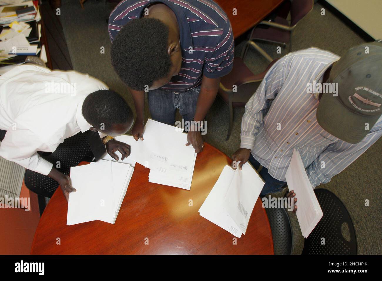 From left, Ajak Dau Akech, Kuol Awan, executive director of the AZ Lost ...