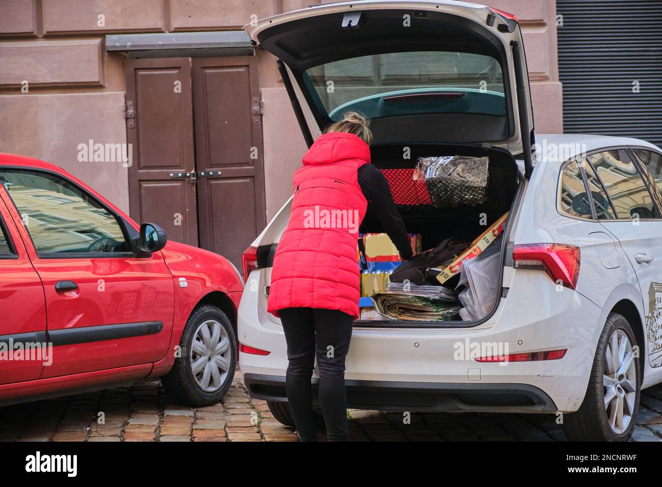 Female Woman putting bags packing product groceries in car trunk ...