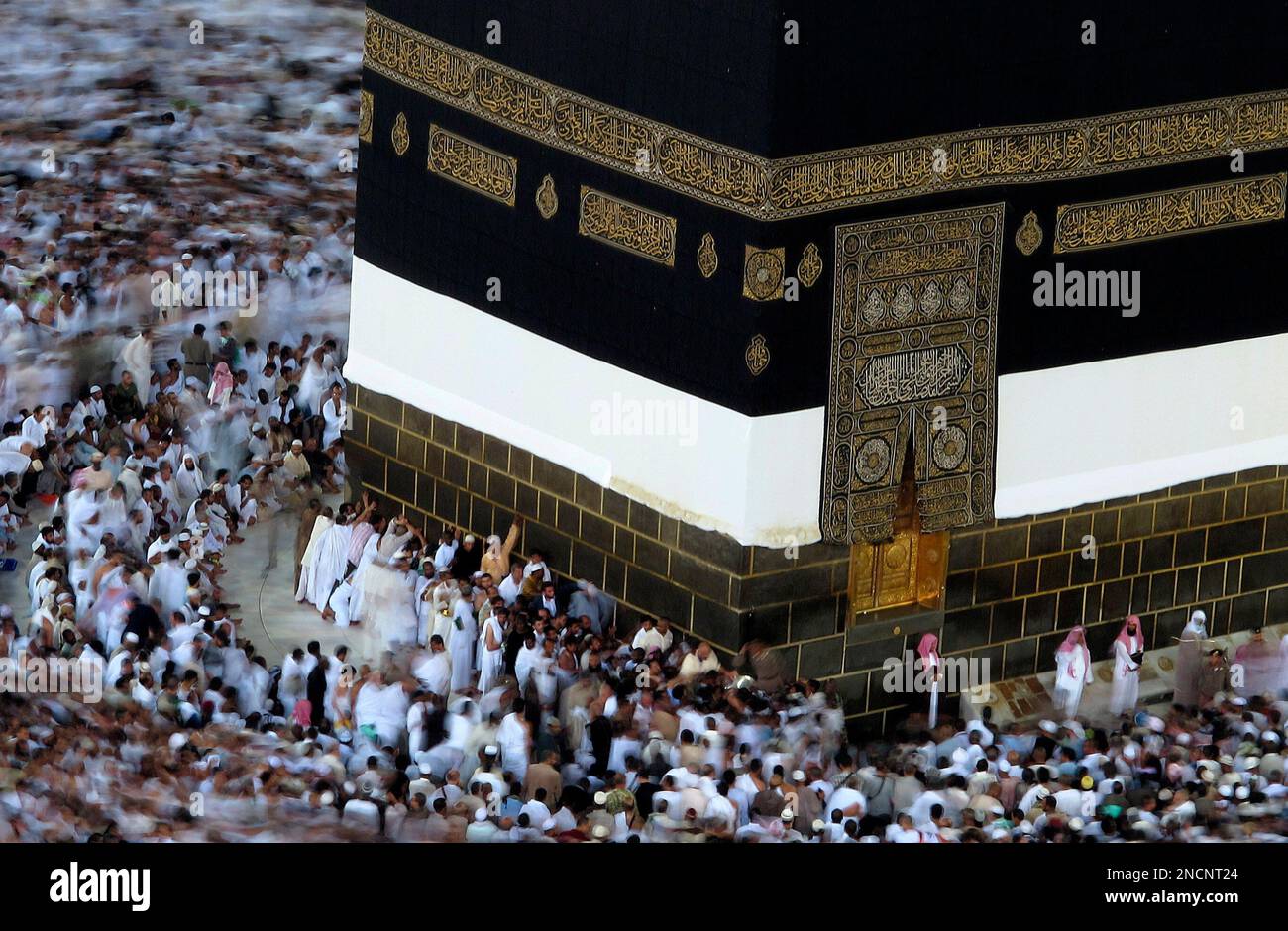 Tens of thousands of Muslim pilgrims moving around the Kaaba, the black ...