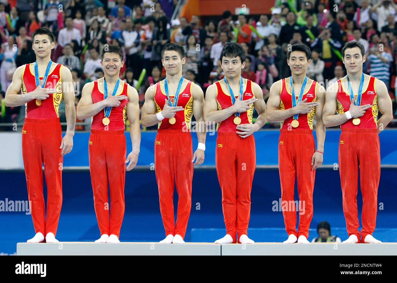 China's men's gymnastics team from left to right, Zhang Chenglong, Chen ...
