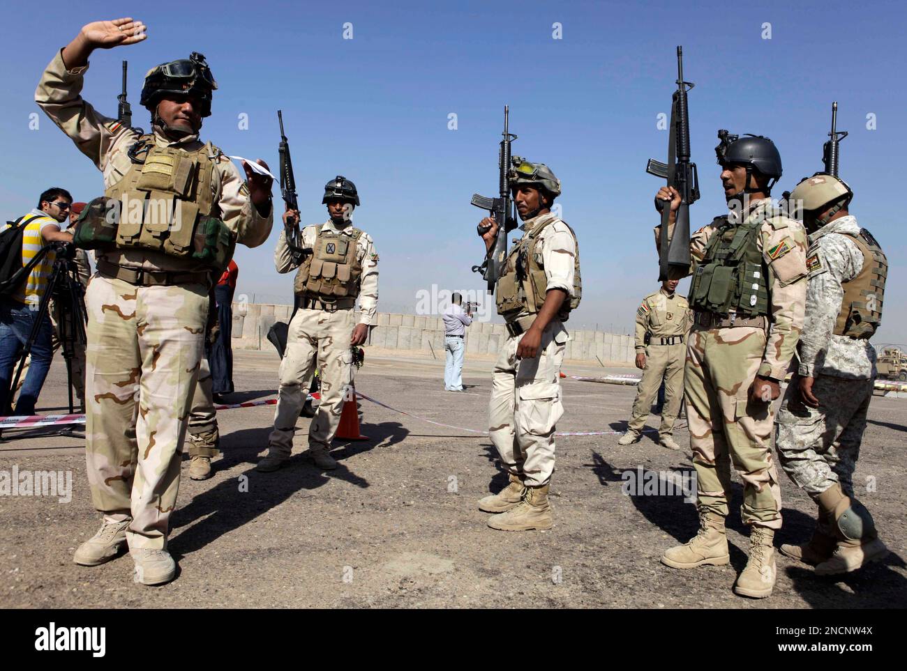 Iraqi Army soldiers dance and chant slogans to celebrate the end of an ...