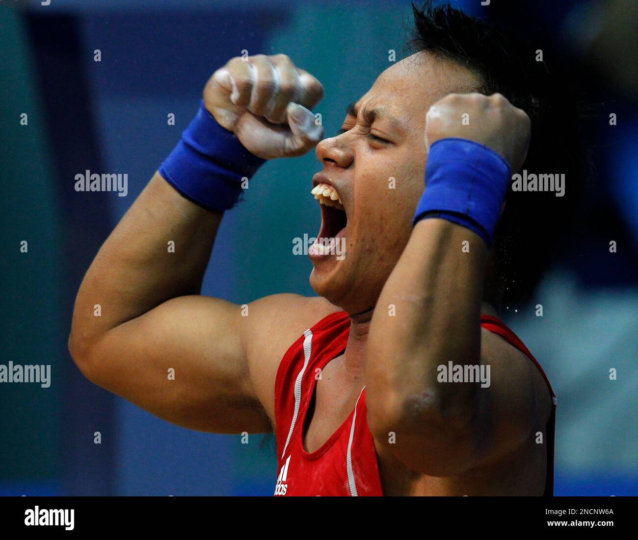 Indonesia's Jadi Setiadi celebrates after a lift in the men's 56 kg ...