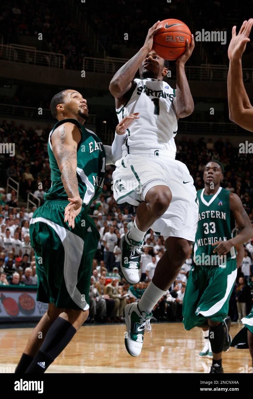 Michigan State's Kalin Lucas, center, drives to the basket between ...