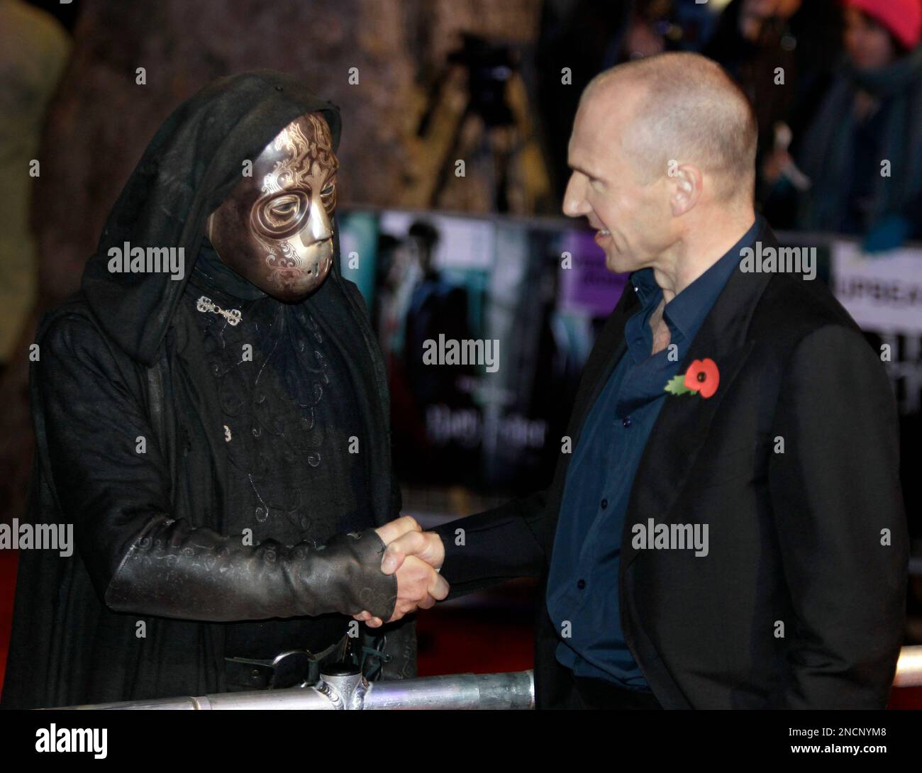Actor Ralph Fiennes, right, poses for the photographers as he attends ...