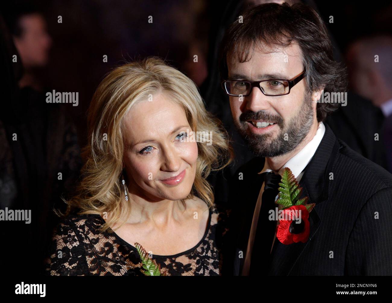 British author JK Rowling, left, accompanied by Neil Murray, poses for ...