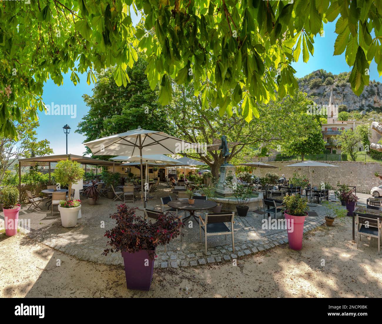 A outdoor cafe under the trees during the summer Stock Photo - Alamy