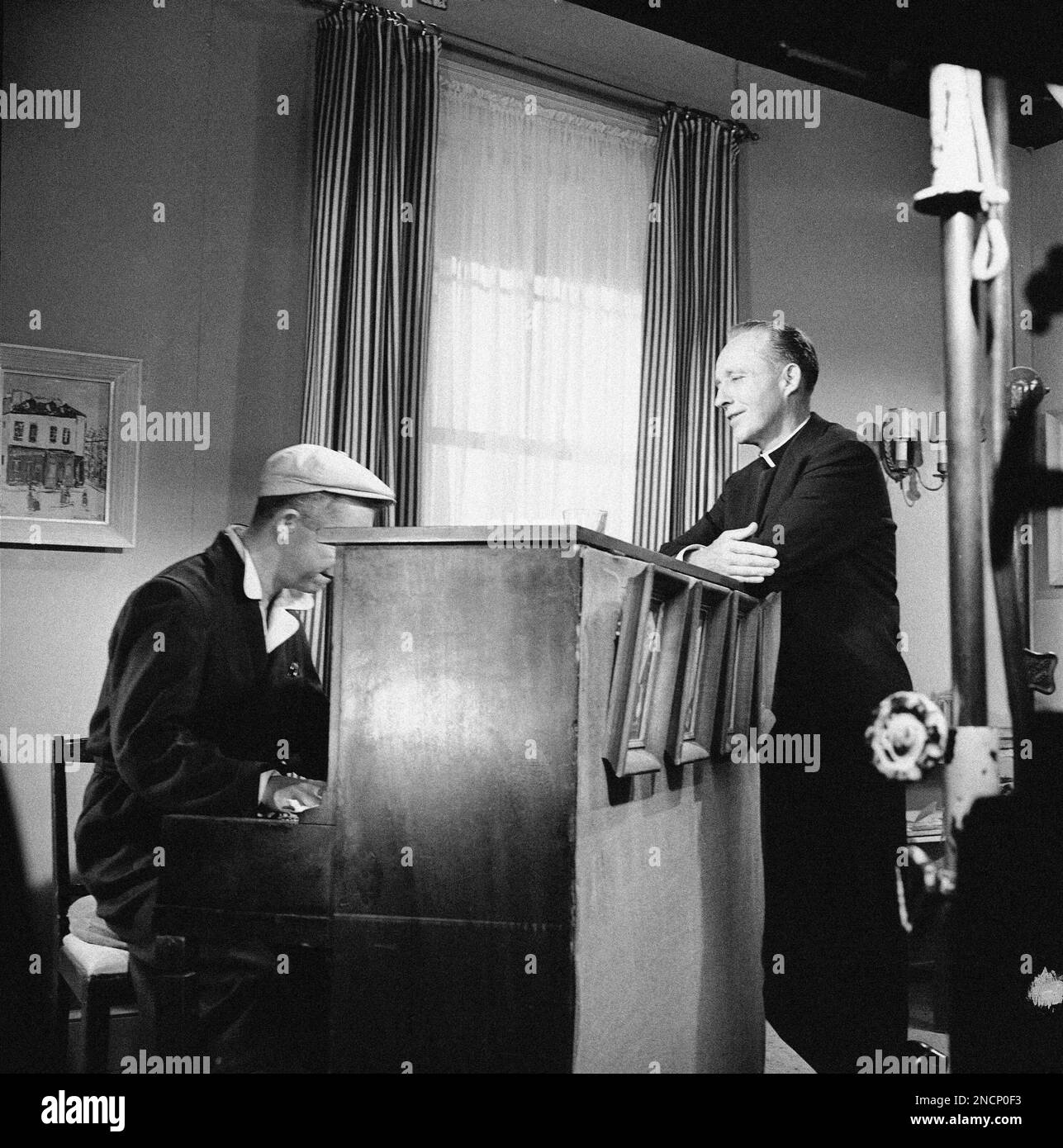 Singer Bing Crosby once again dons the robes of a priest of his role in ...