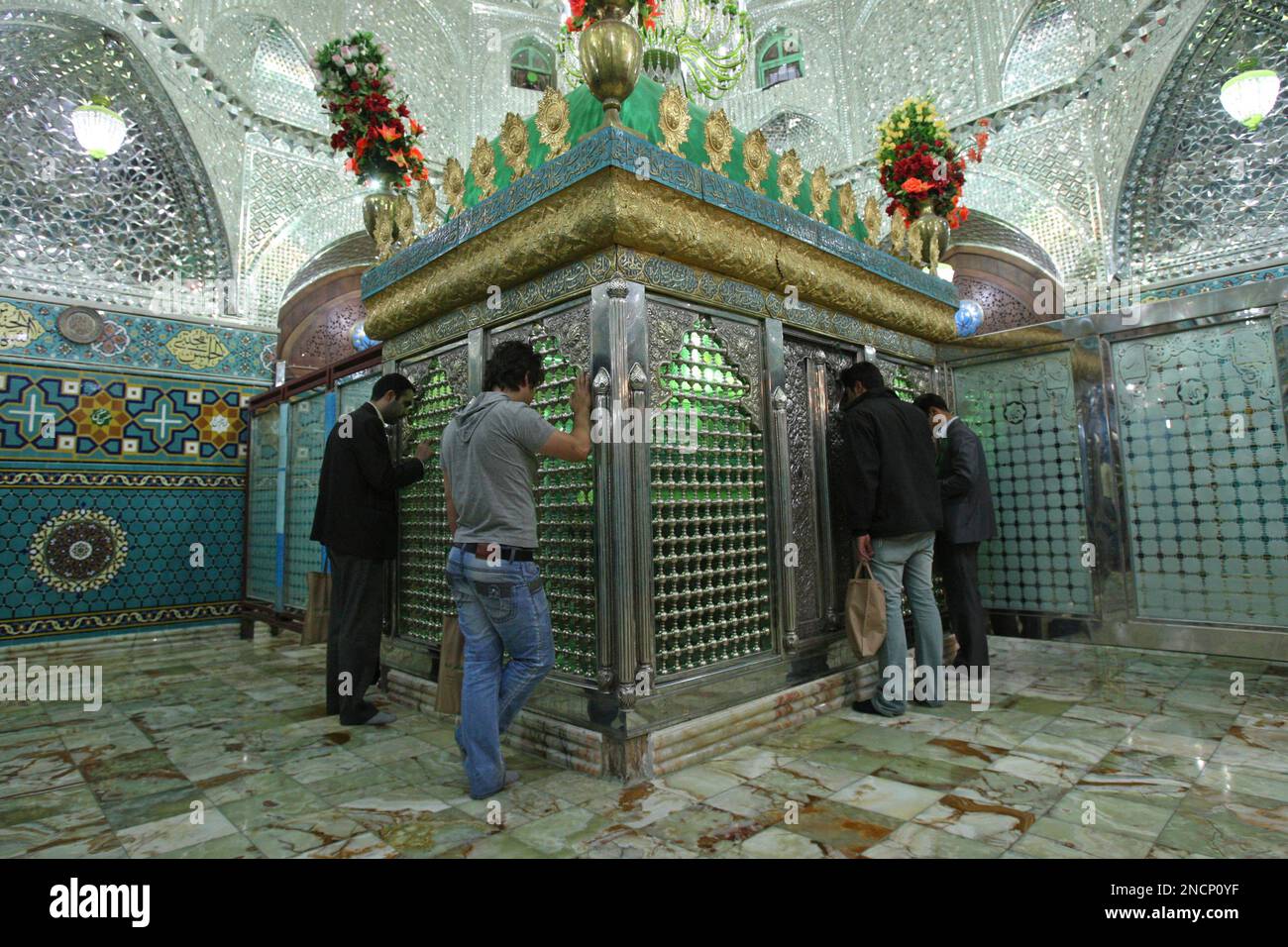 Iranian pilgrims touch bars of the grave of Shiite Saint Davoud, as the ...