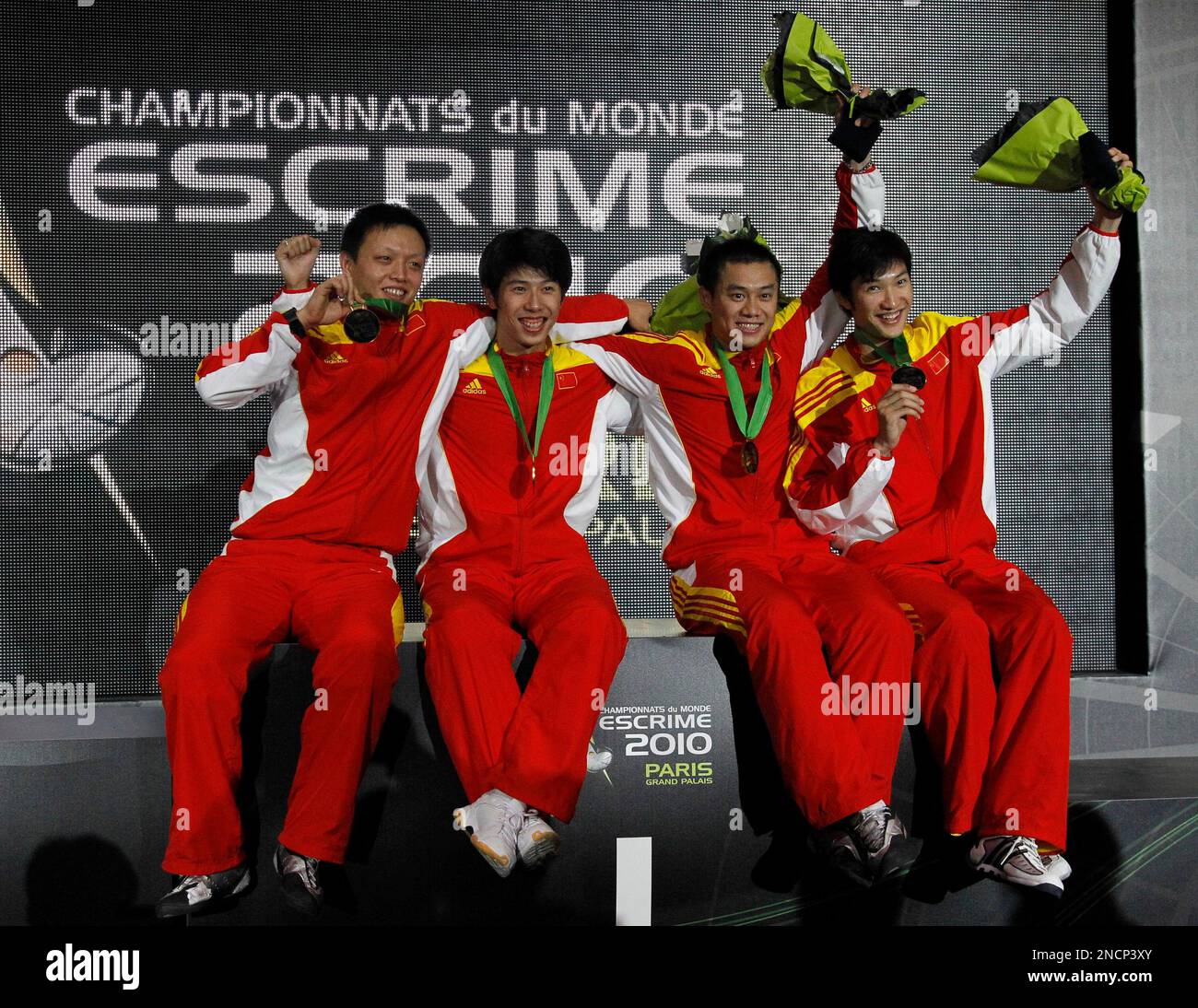 Chinese fencing team celebrate its gold medal on the podium after ...