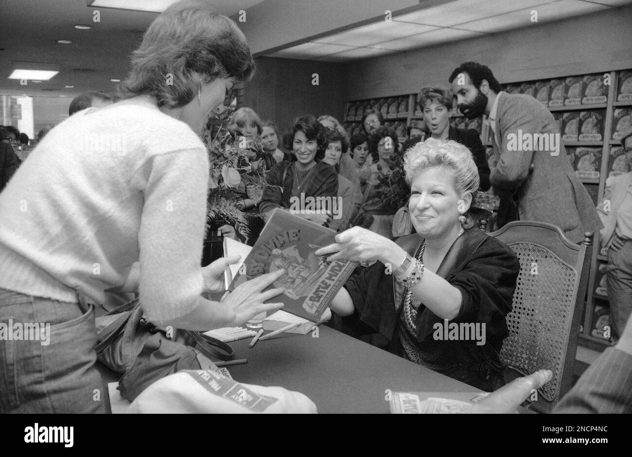 Actress and singer Bette Midler signs autograph in her book "Baby ...