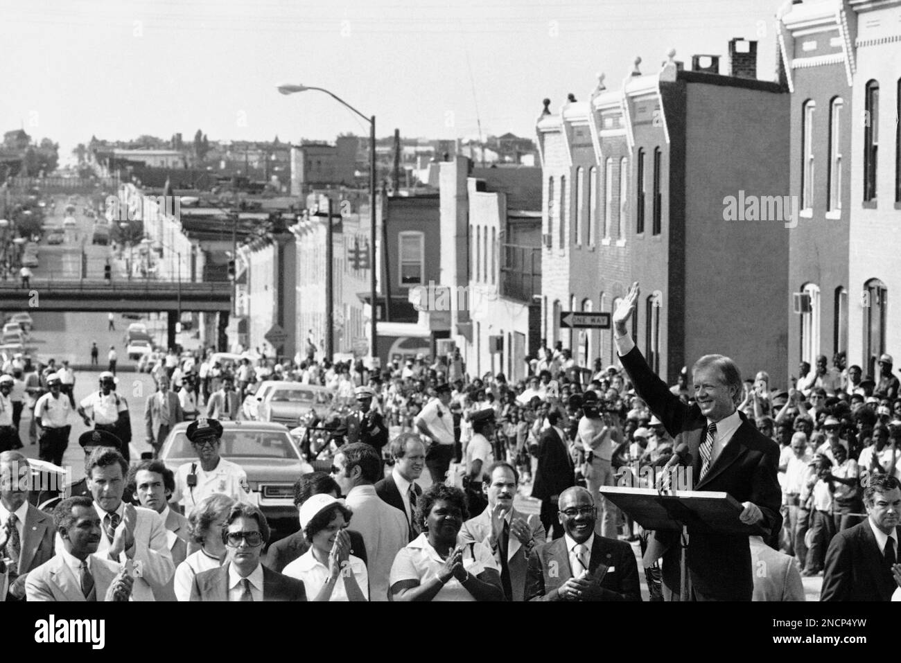 U.S. President Jimmy Carter wave to a crowd gathered in the street in ...