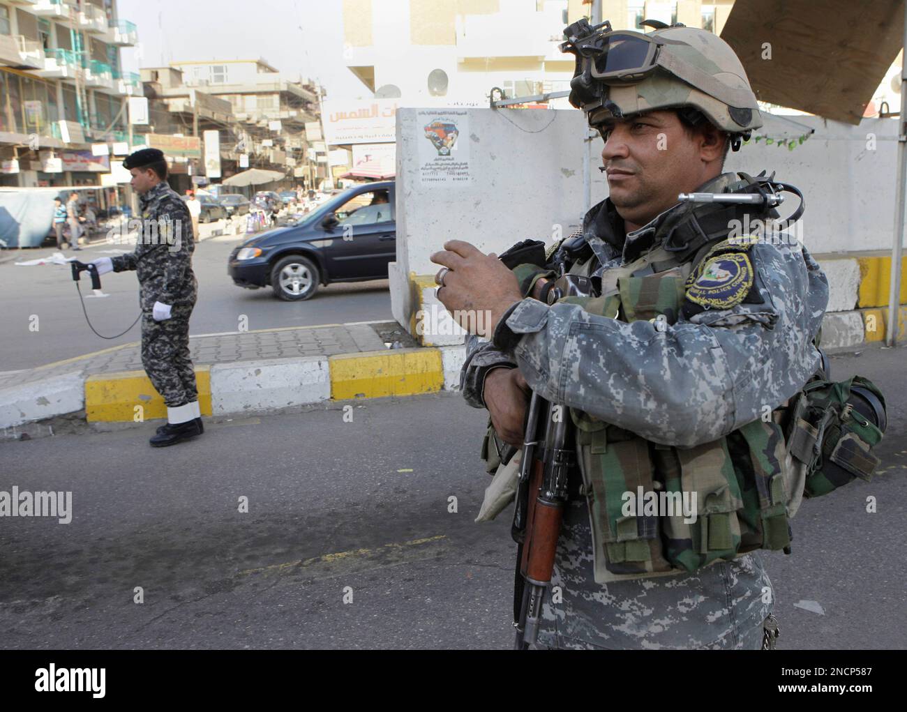 Iraqi policemen are seen at a check point in Baghdad, Iraq, Thursday ...
