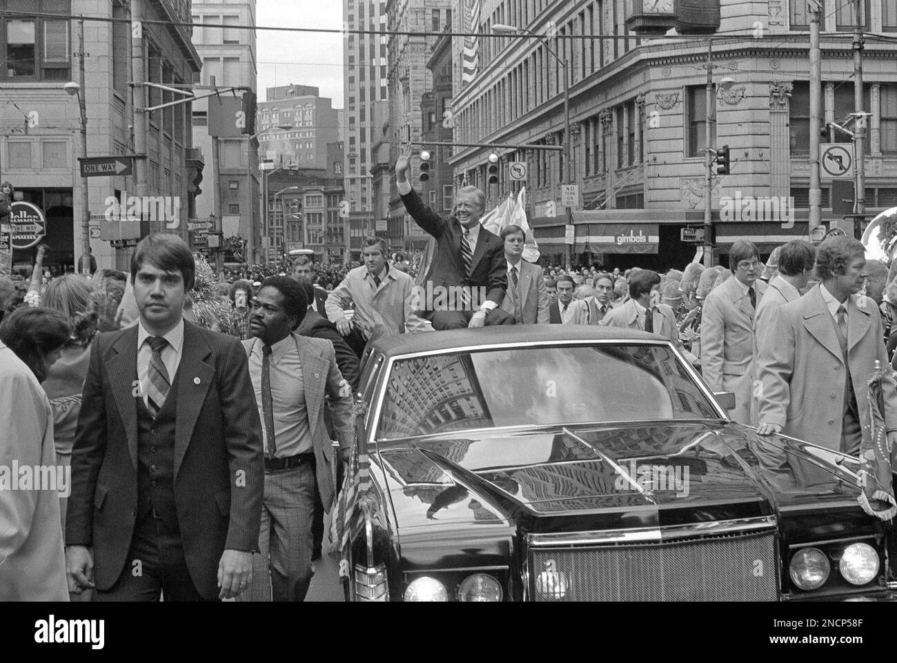 President Jimmy Carter waves from the top of his limousine as he leaves ...
