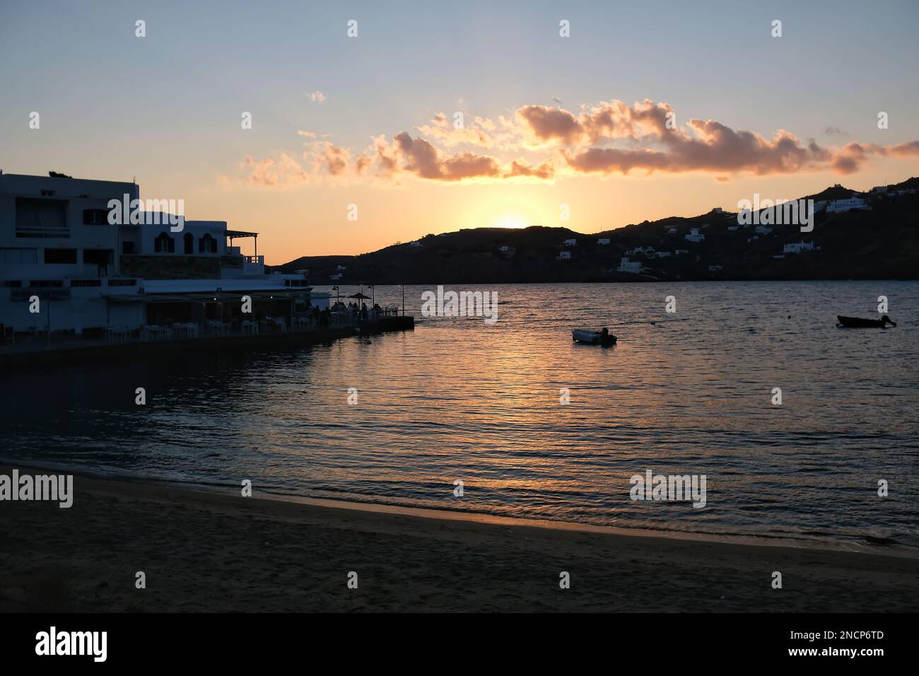 View of a beautiful sunset at the Mylopotas beach in Ios Greece and a ...