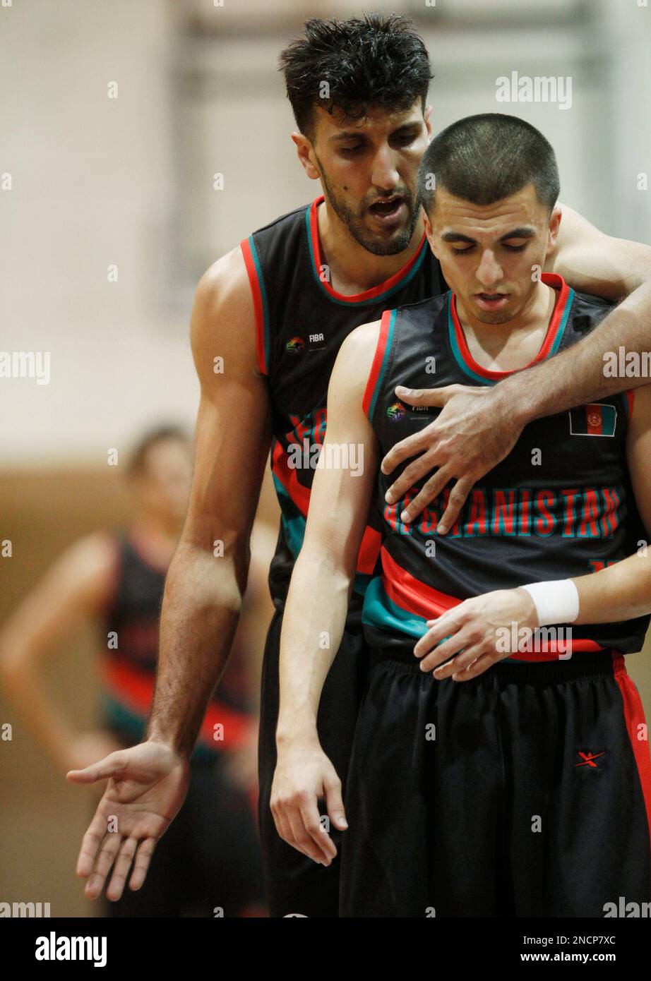 Afghanistan's Nafi Mashriqi, left, congratulates guard Safi Mojaddidi ...