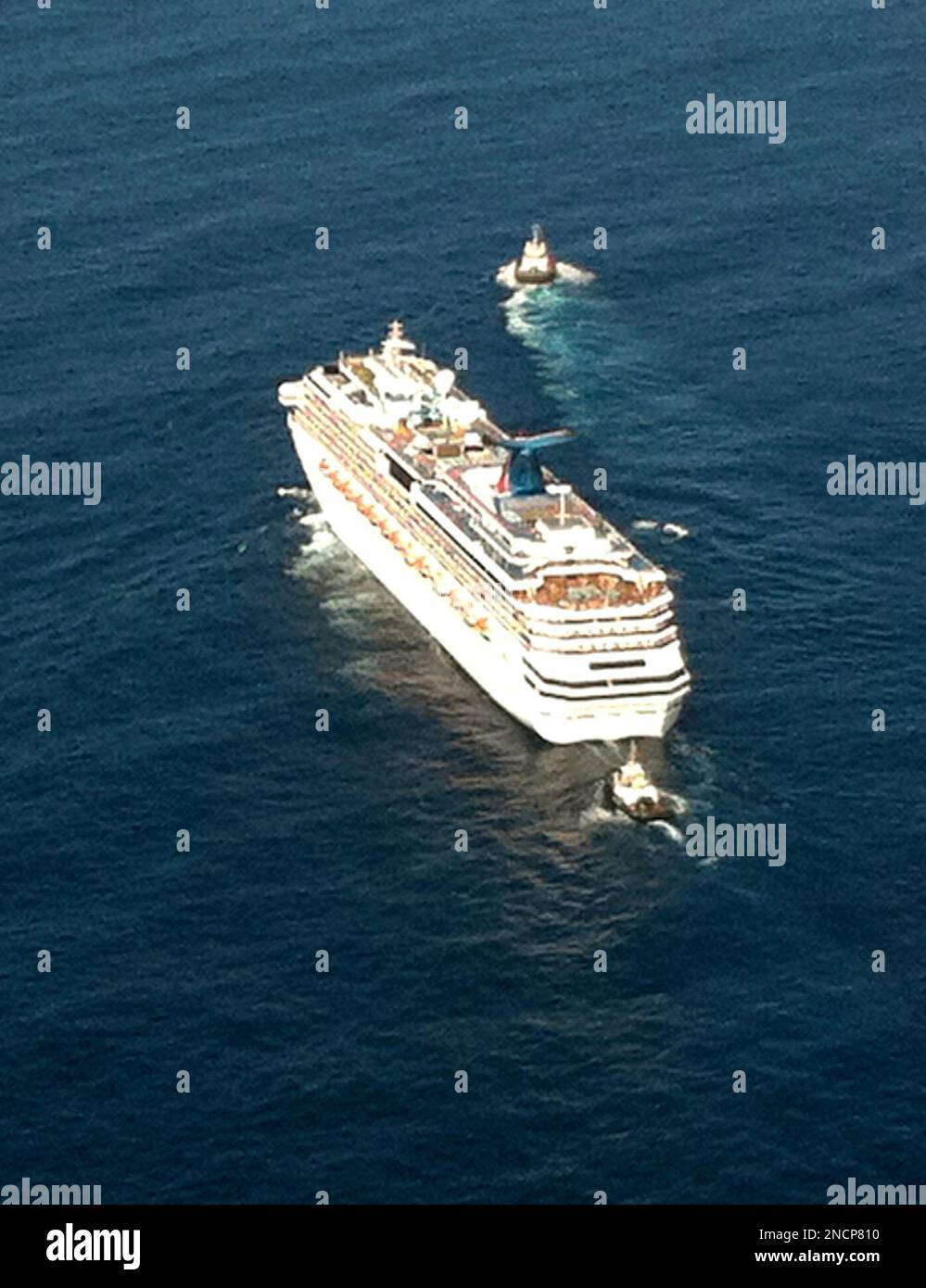 A tug boat pulls the Carnival Splendor cruise ship Wednesday Nov. 10 ...