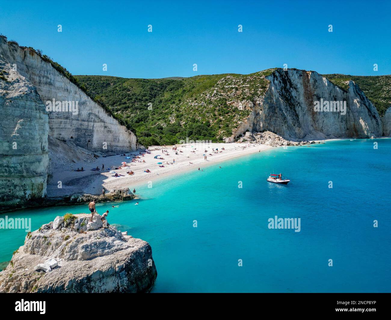 4K Angle shot of couple on a rock at Fteri Beach, Kefalonia, Cephalonia ...