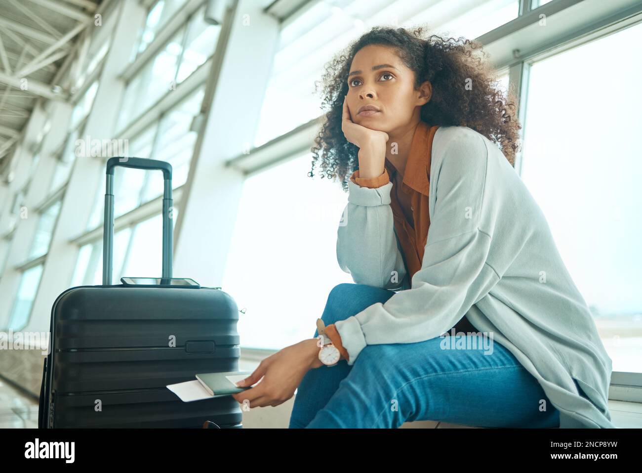 Airport, travel delay and sad woman with anxiety for immigration ...