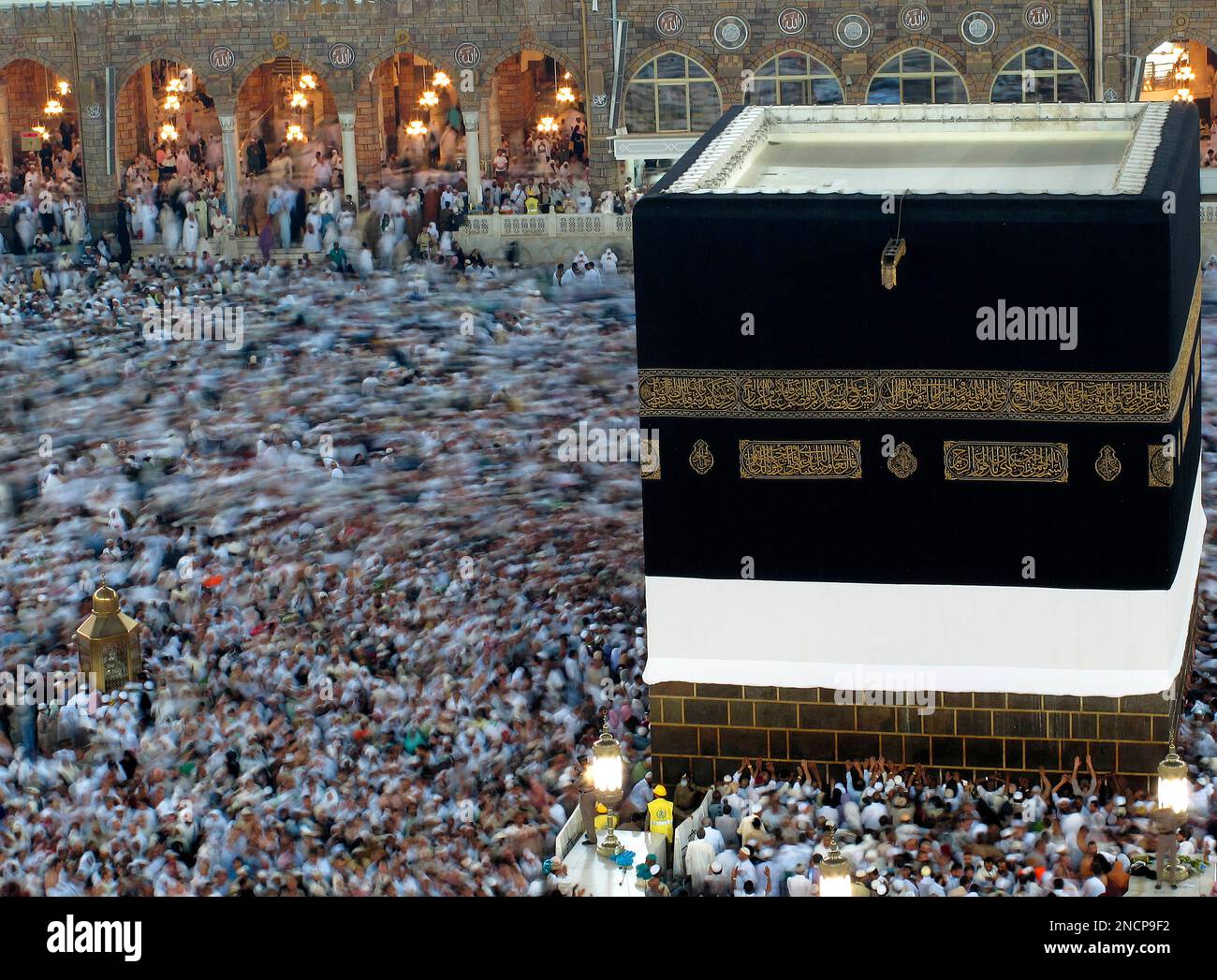 Tens of thousands of Muslim pilgrims moving around the Kaaba, the black ...