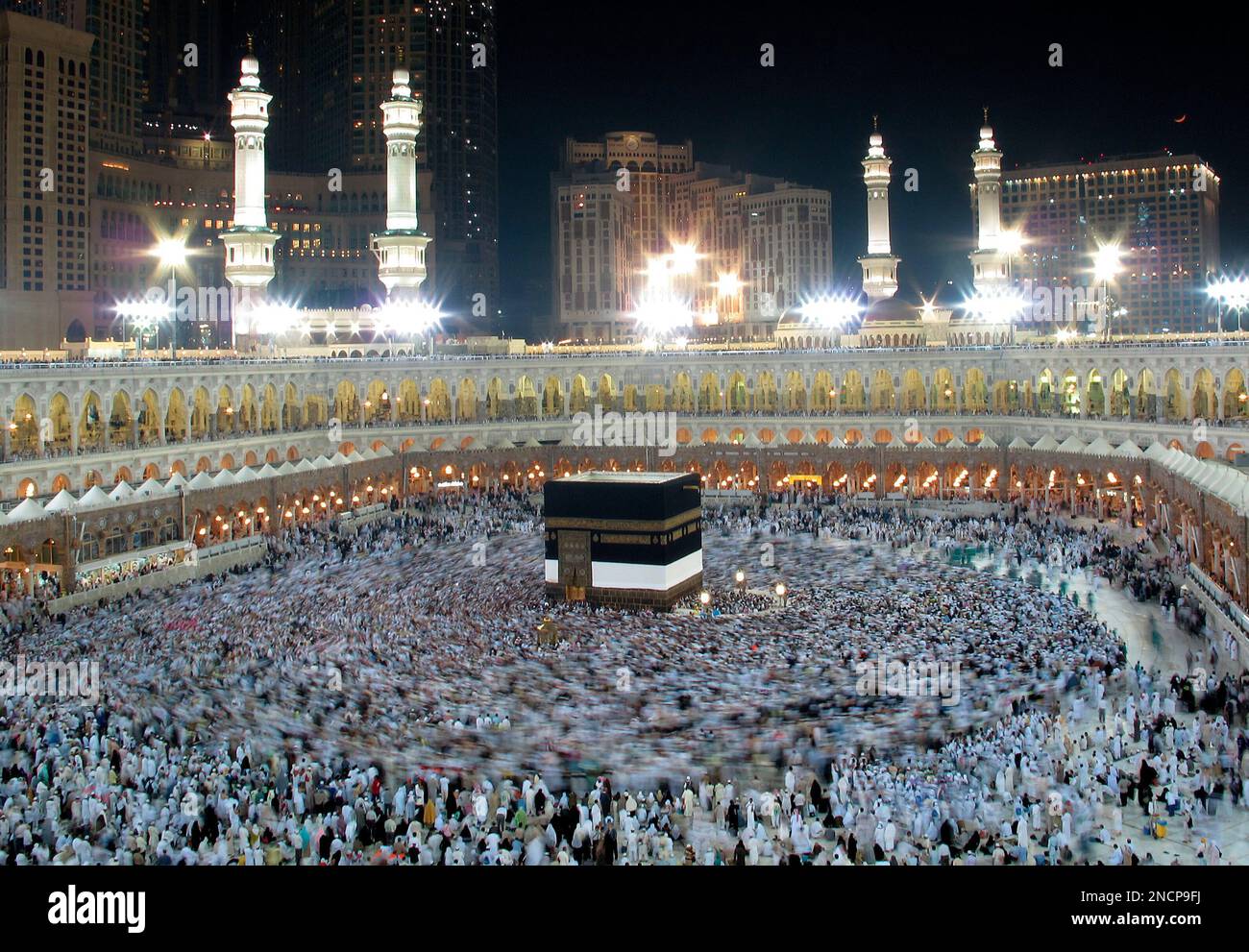 Tens of thousands of Muslim pilgrims moving around the Kaaba, the black ...
