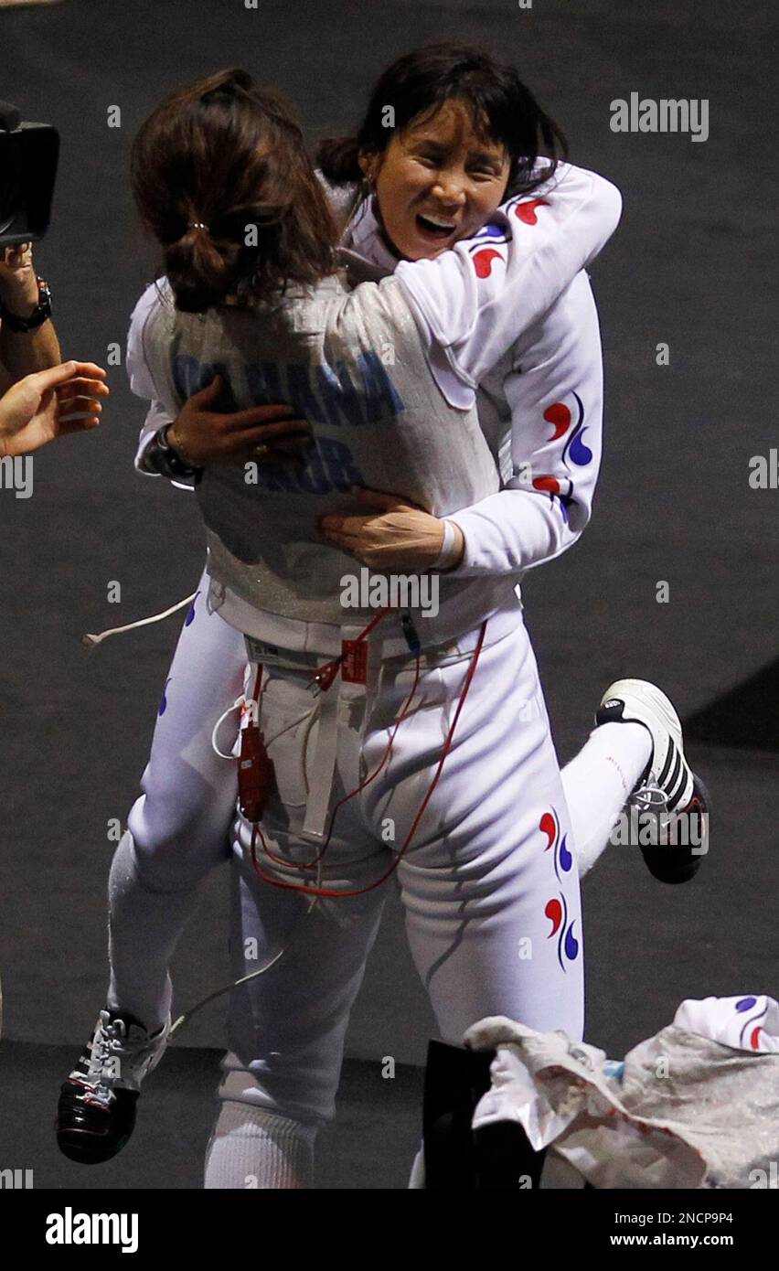 South Korea's Hyun Hee Nam, right, hugs Ha Na Oh after the women's foil ...