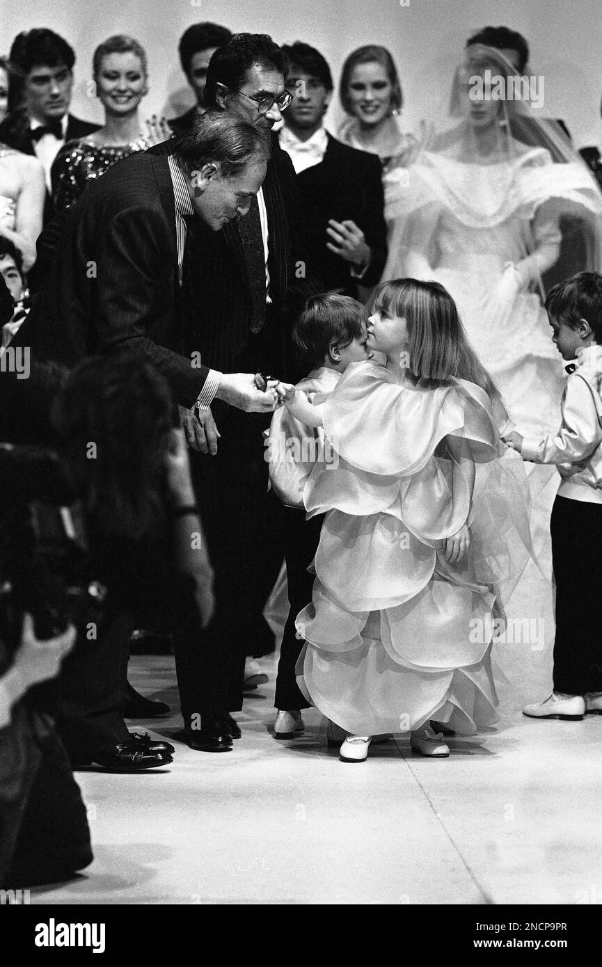 French designer Pierre Cardin congratulates a young model who wears a ...