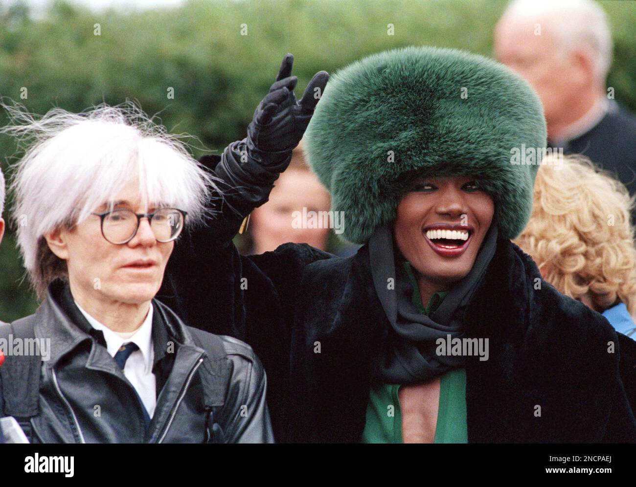 Artist Andy Warhol, left, and actress Grace Jones, right, react to the ...