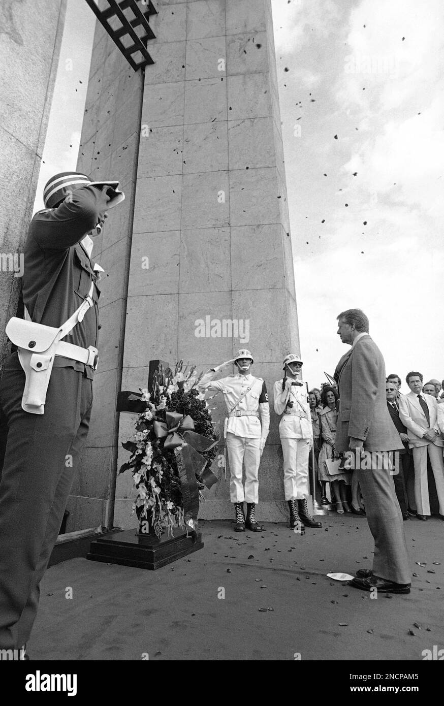 President Jimmy Carter stands at attention saluting the war dead at Rio ...