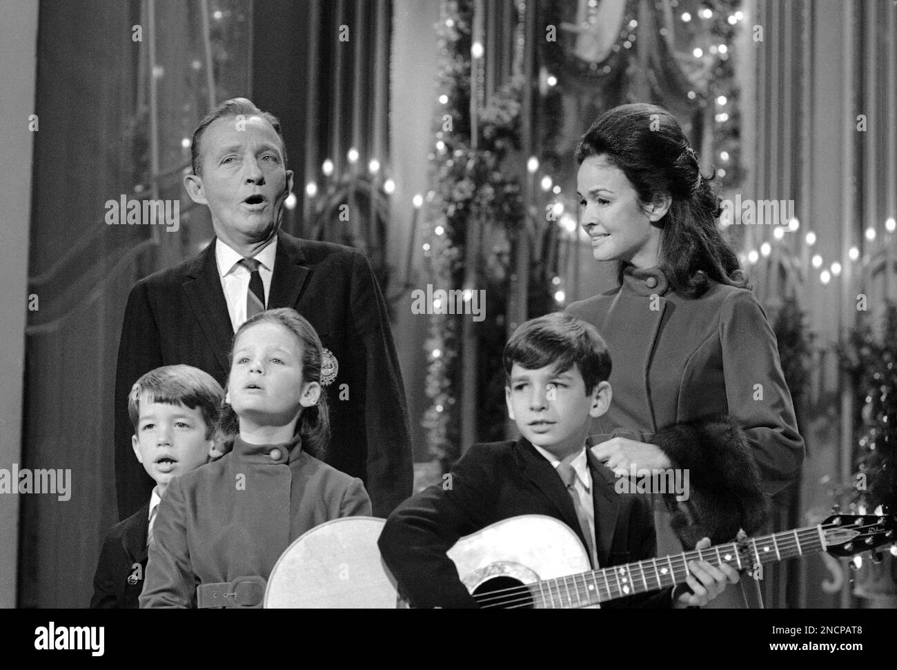 Bing Crosby belts out a tune, joined by his wife, Kathryn, and their ...