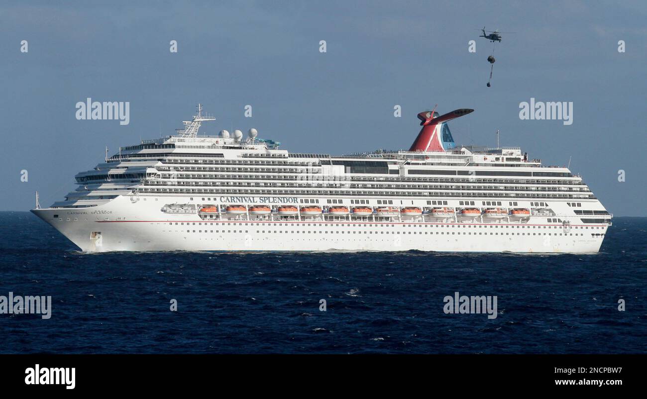 A Navy Seahawk helicopter brings supplies to the Carnival Splendor ...