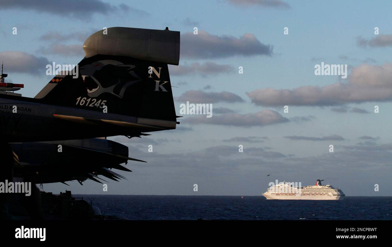 A Navy Seahawk helicopter brings supplies to the Carnival Splendor ...