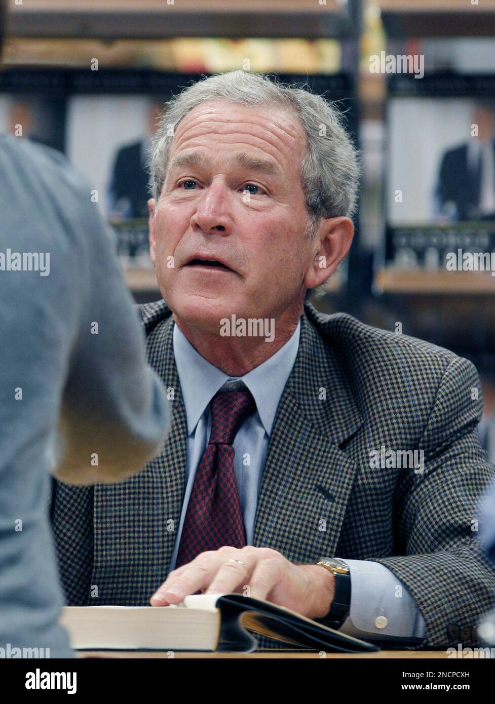 Former President George W. Bush while signing copies of his book in ...