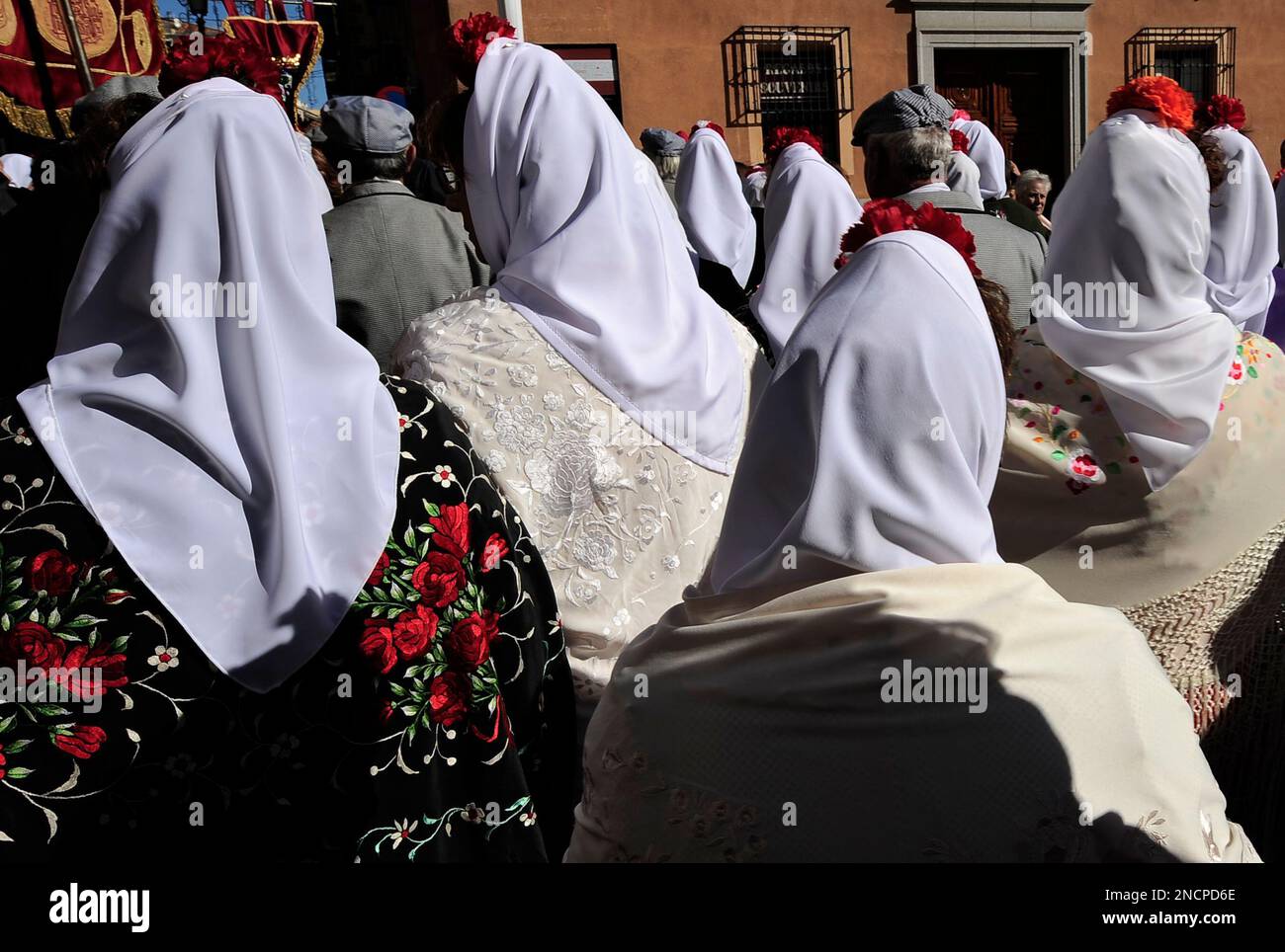 People wearing traditional dress walk on Mayor Square to mark Saint ...