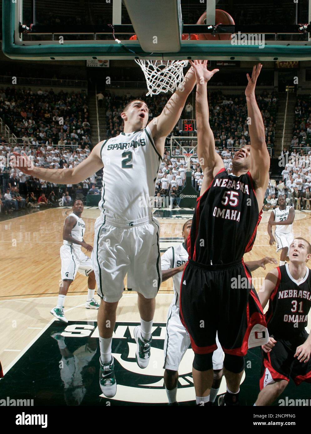 Michigan State's Alex Gauna (2) and Nebraska-Omaha's Matt Starks (55 ...