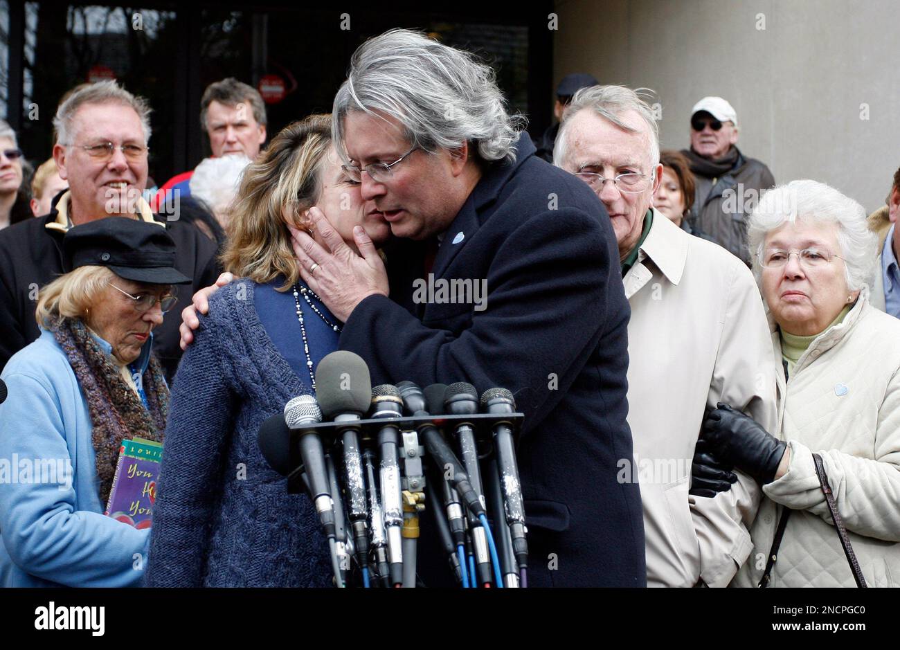 Hanna Chapman, left, hugs her brother Dr. William Petit Jr., right, as ...