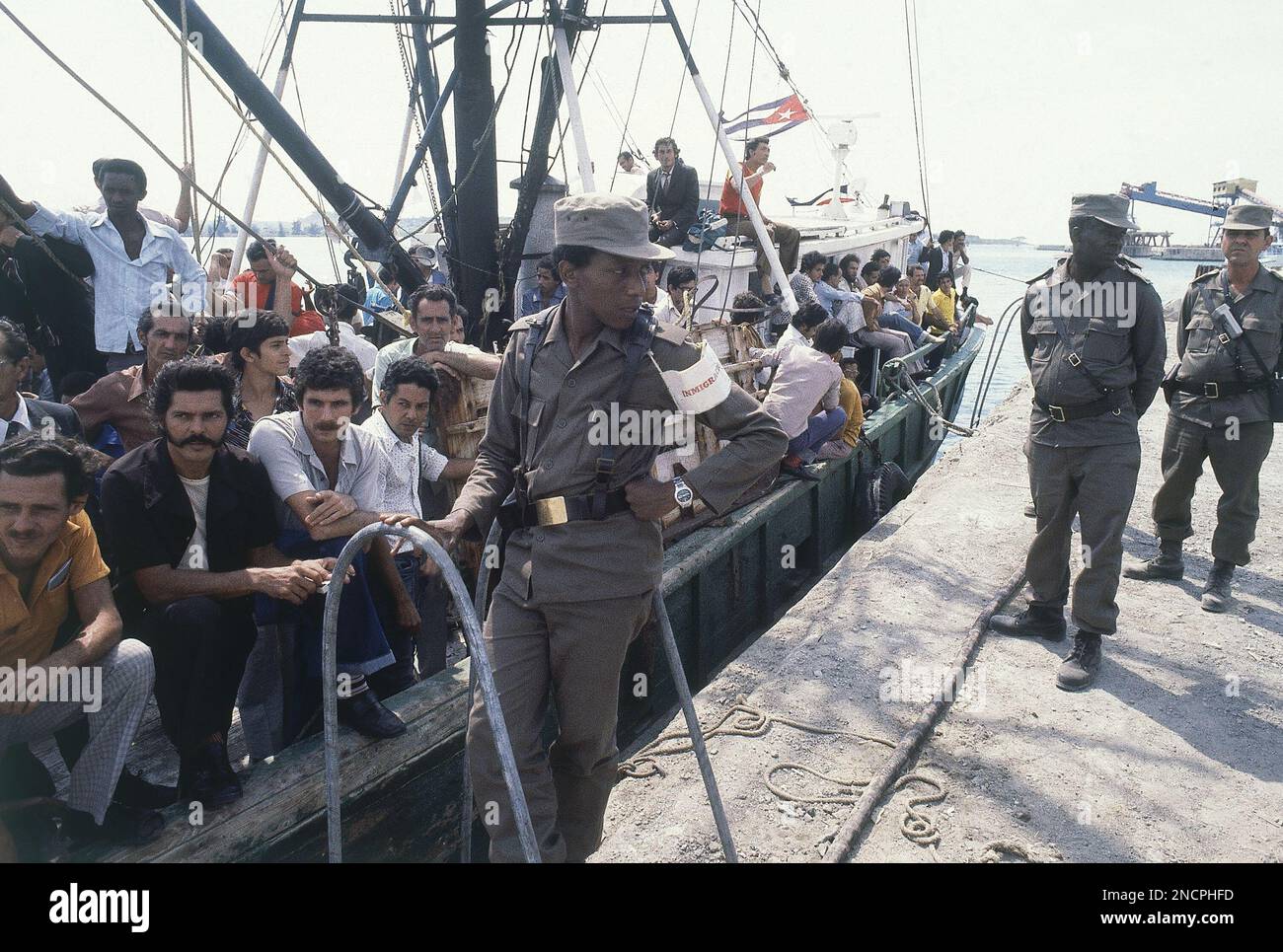 A Cuban soldier stands by a refugee ship at the small port of Mariel ...