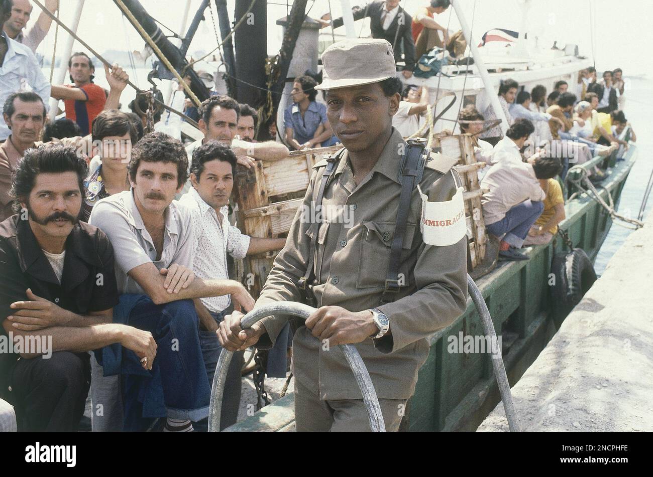 A Cuban soldier stands by a refugee ship at the small port of Mariel ...