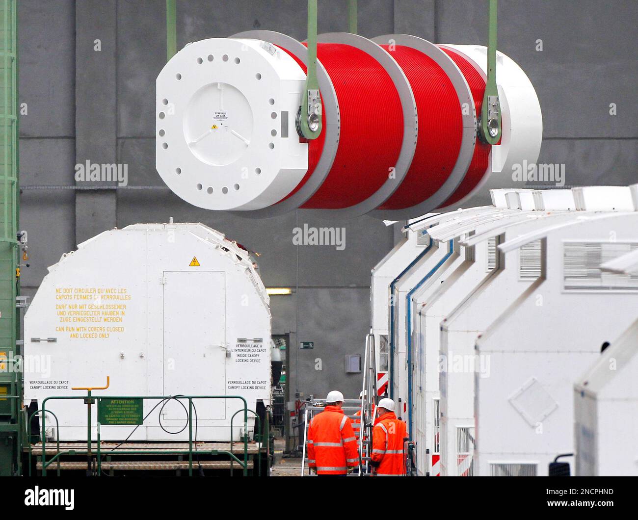 A container with nuclear waste is loaded from a train onto a a truck in ...
