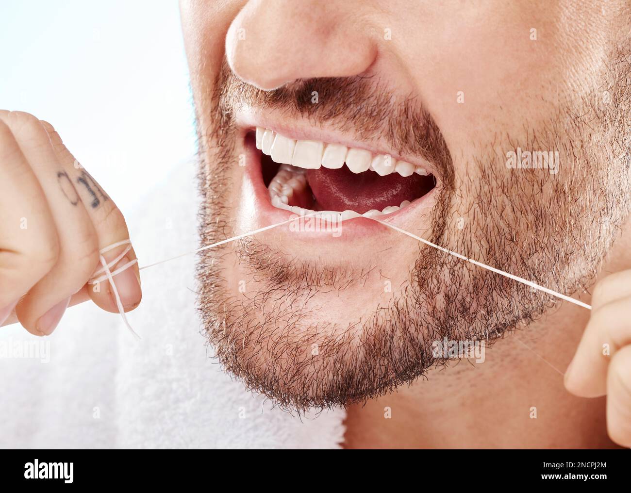 Dental, hygiene and man flossing his teeth in a studio for oral care, grooming or health ...