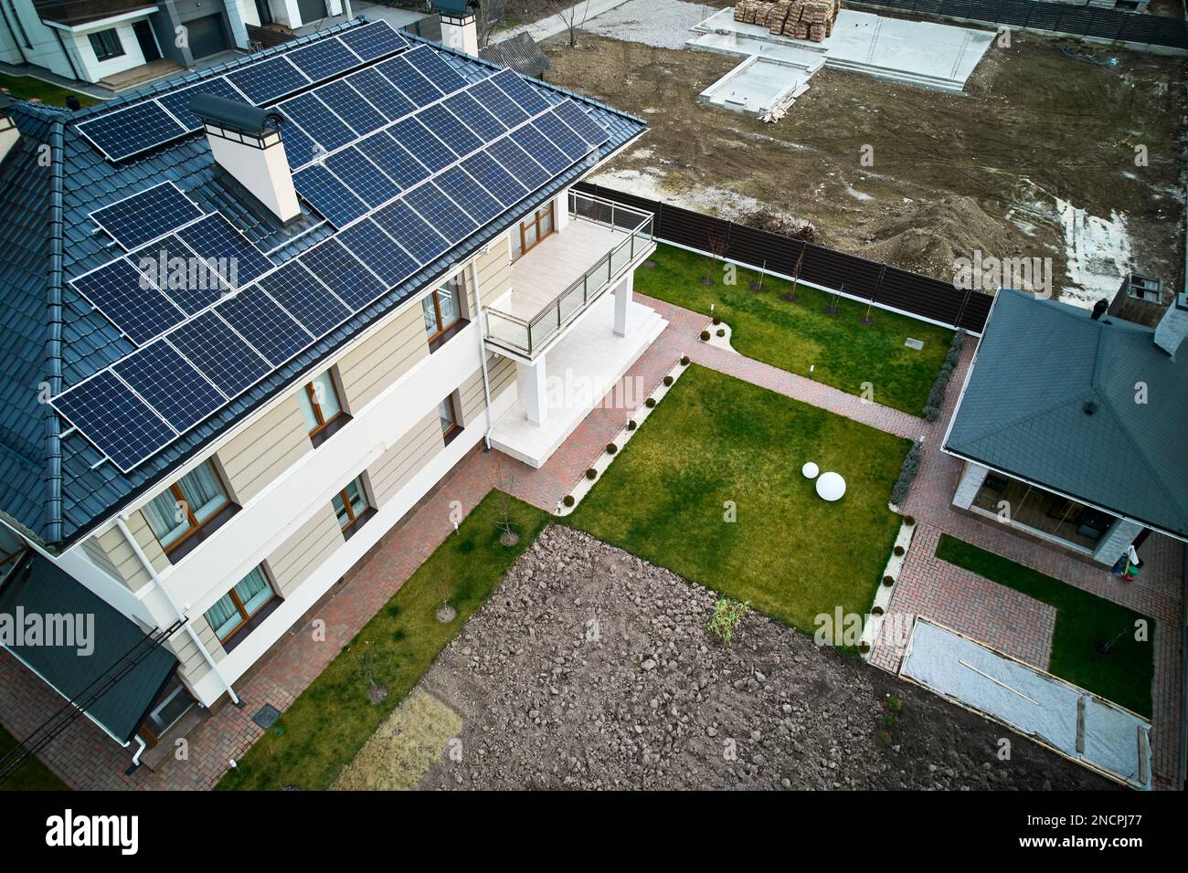 Aerial view of residential house with photovoltaic solar panel modules ...