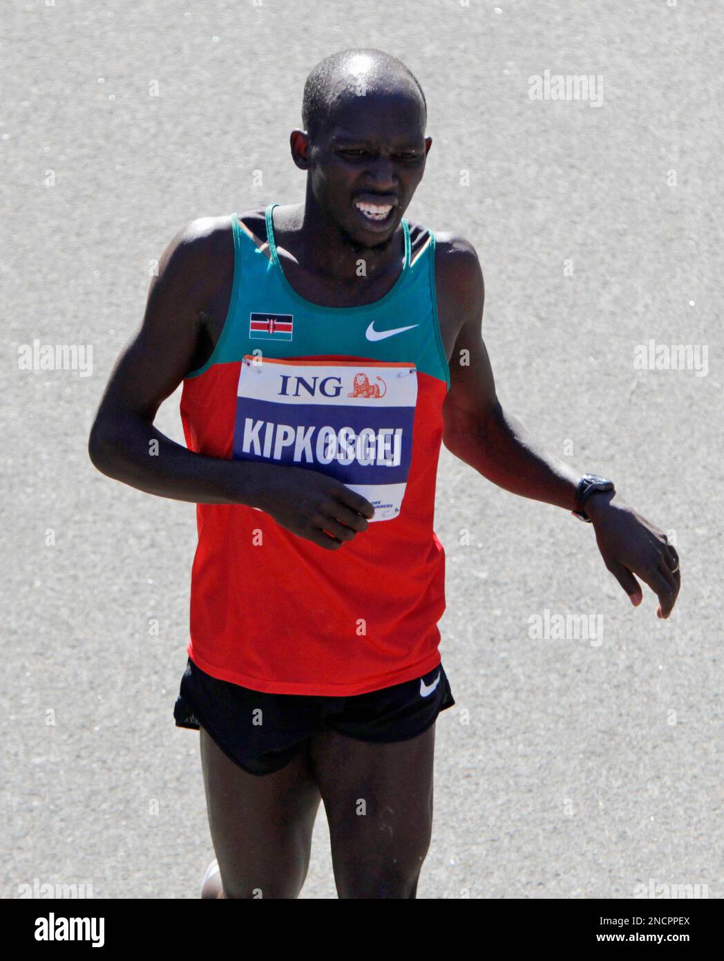 Moses Kigen Kipkosgei, of Kenya, crosses the finish line third in the ...