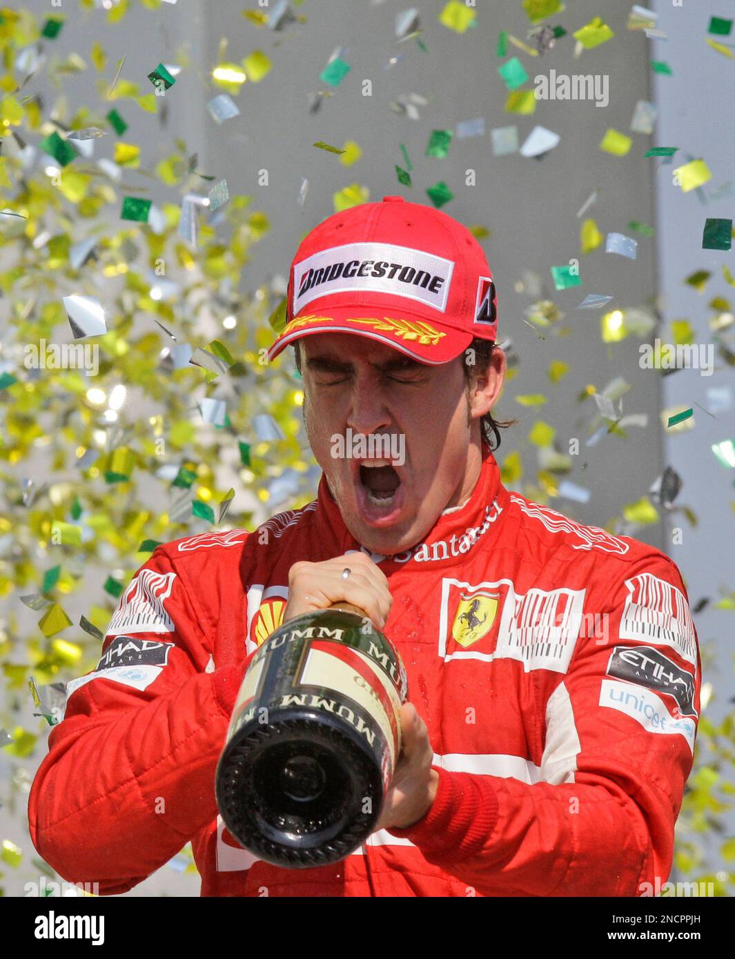 Ferrari driver Fernando Alonso of Spain celebrates on the podium after ...