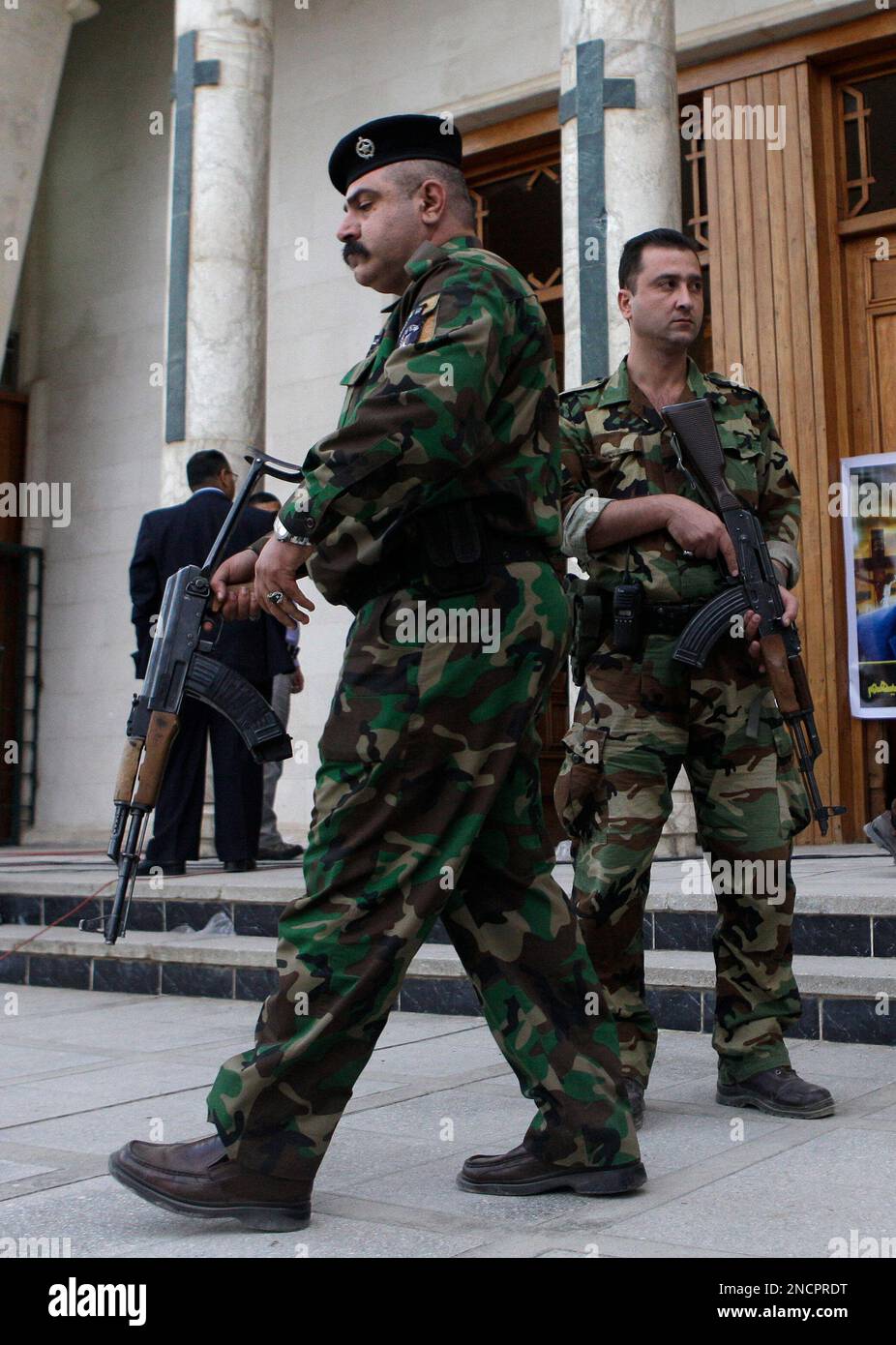 Iraqi security forces stand guard during a mass at Our Lady of ...
