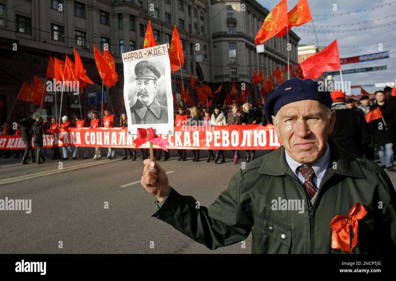 A Communist party supporter carries portrait of former Soviet dictator Joseph Stalin during a ...