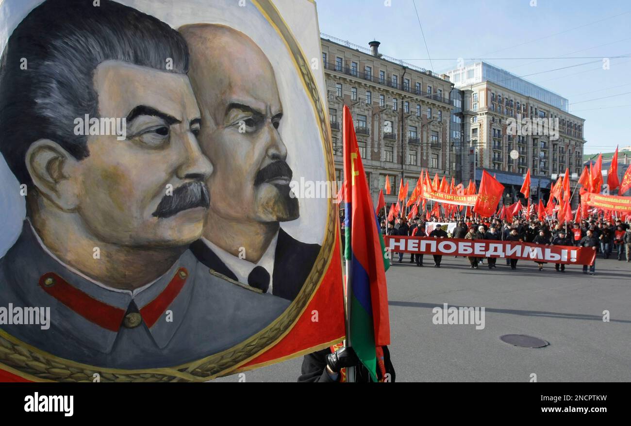Communist party supporters hold a poster depicting former Soviet ...
