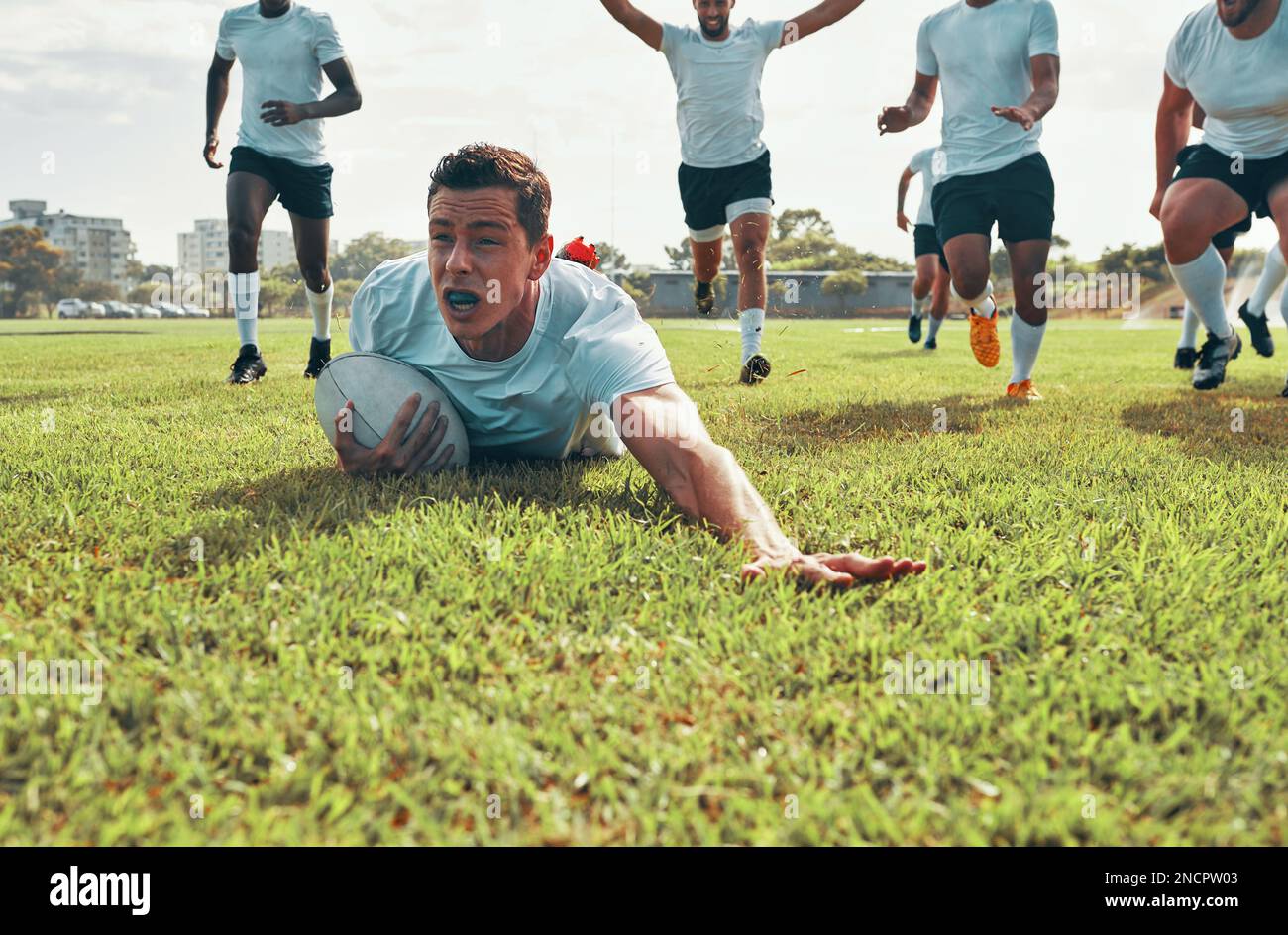 We play to win. a rugby player scoring a try while playing on a field ...
